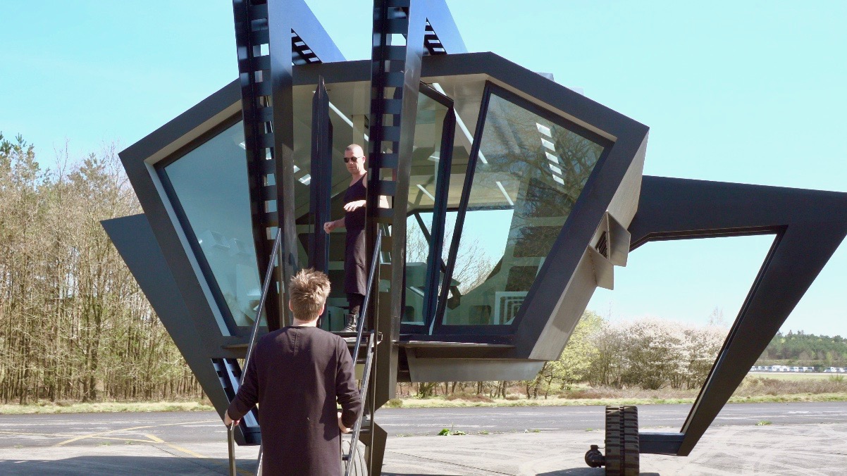 Black-mantis vehicle uses a Cold War hangar as creative burrow ...